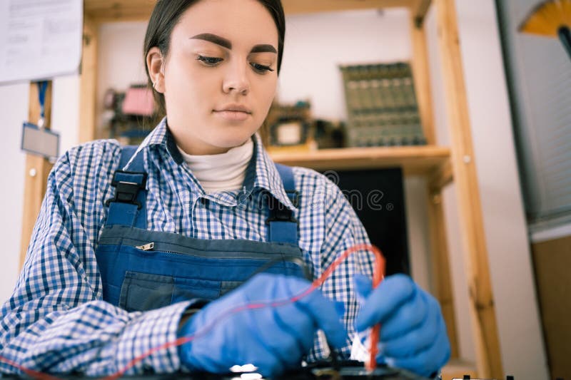 Computer Repair, Young Woman Cleaning Laptop Fan with Small Brush ...