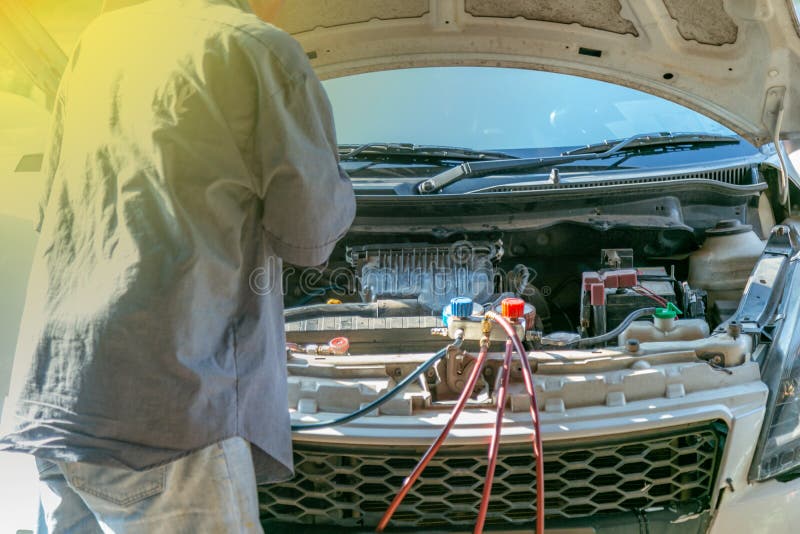 Technician Checking Air Conditioner in Engine Room of Eco Car ...