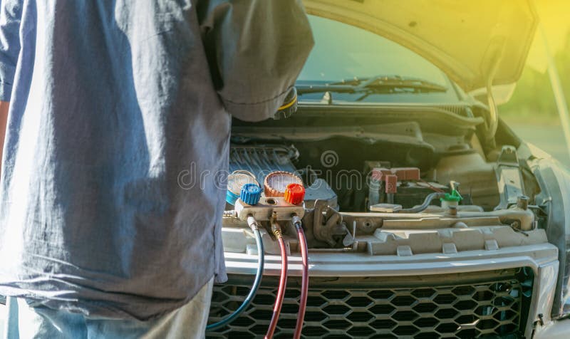 Technician Checking Air Conditioner in Engine Room of Eco Car ...