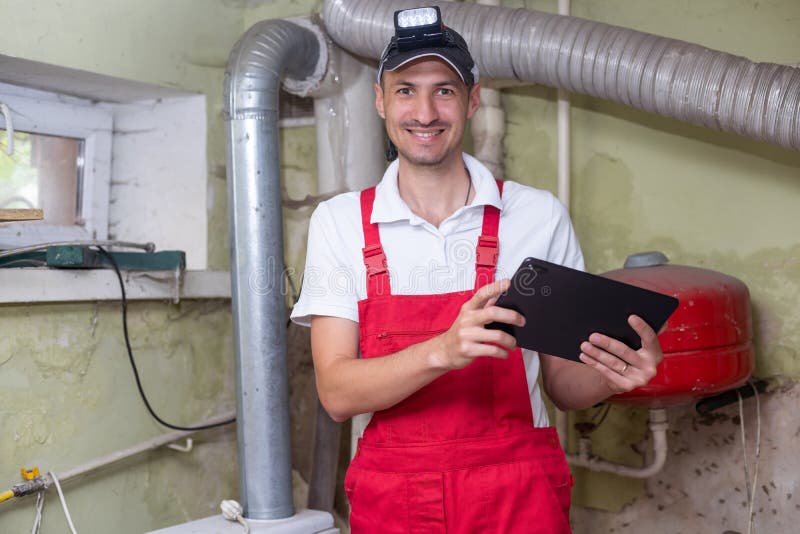 The Technician Checking the Heating System in the Boiler Room with ...