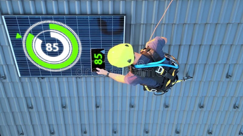 Technician Checking Power Levels of a Installed Solar Panel on a House ...