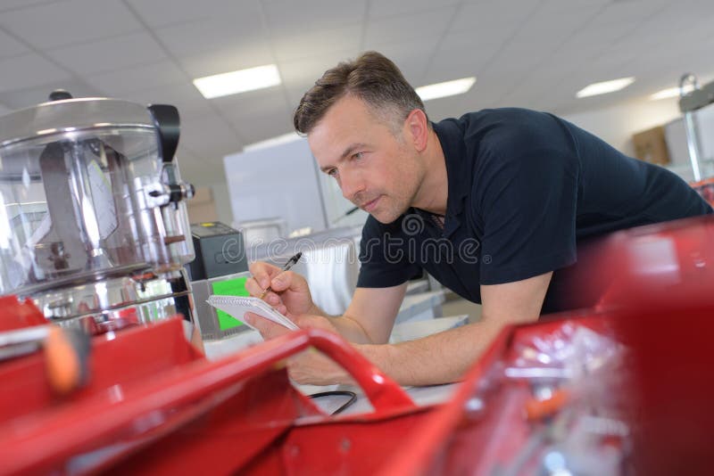Technician with Clipboard Near Machine Stock Photo - Image of ...