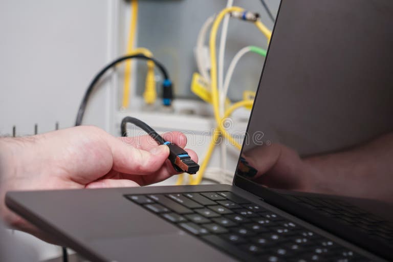 Technician Connecting Ethernet Cable To Laptop for High Speed Internet ...