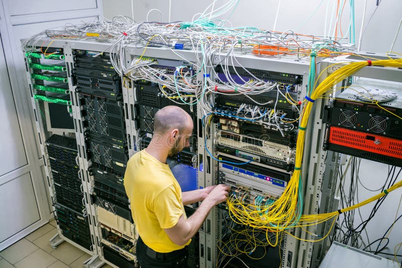 A Technician Connects Internet Backbones with a Central Router. Worker ...