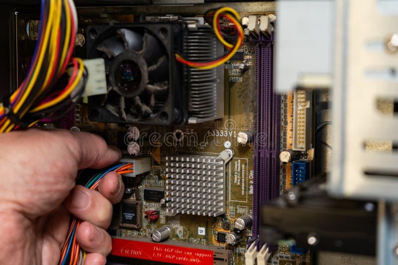 A Technician Disconnecting the Power Supply from a Computer Motherboard ...