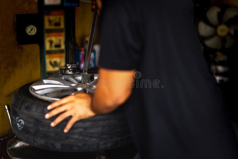 The Technician Doing Take Off Tire Car Wheel before Repaired Tire Stock ...