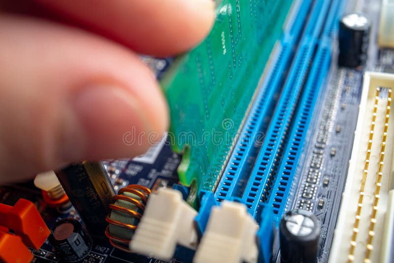 Technician Engineer Inserts the RAM into the Motherboard Slot. the ...