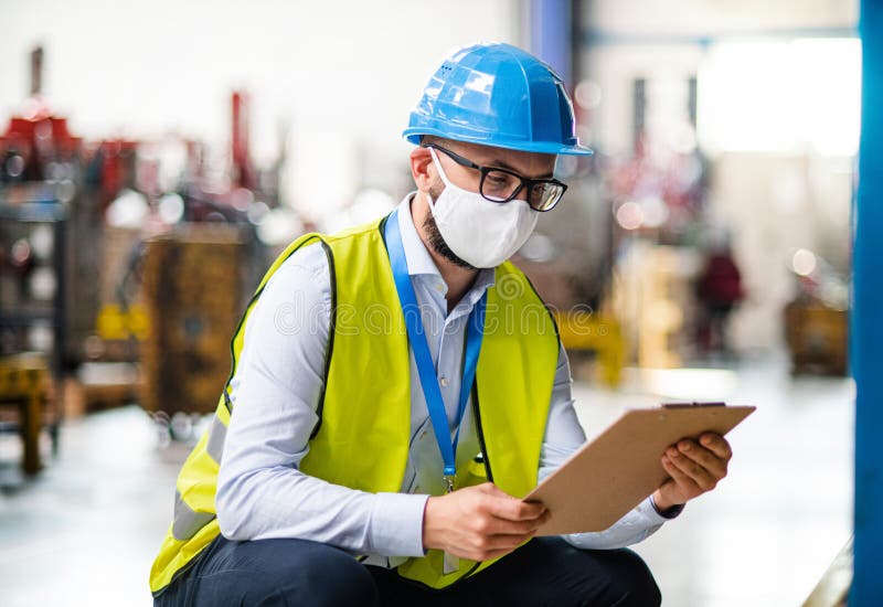 Technician or Engineer with Protective Mask and Helmet Working in ...