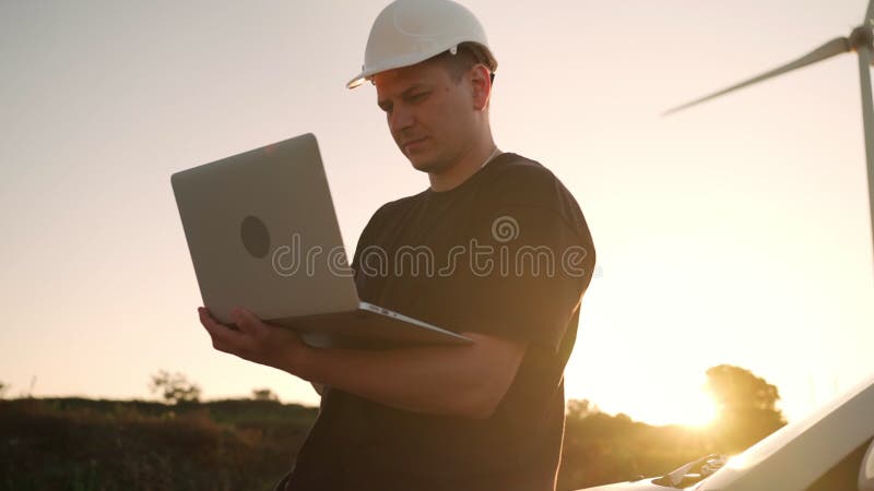 Technician Engineer Working at Wind Turbine Using Laptop Computer ...