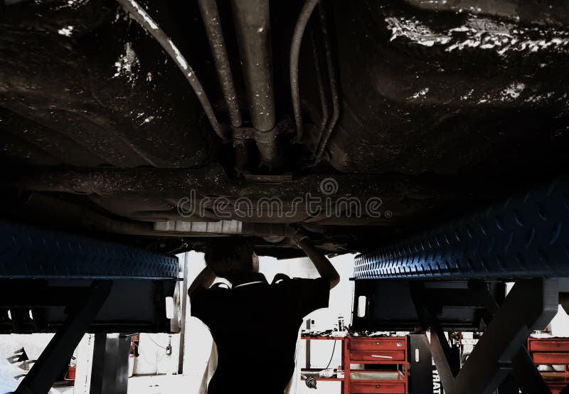 Technician Fixing Auto Car Service from Under Lift at Garage Stock ...