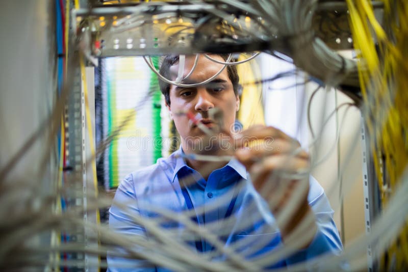 Technician fixing cable stock image. Image of attentive - 78692693