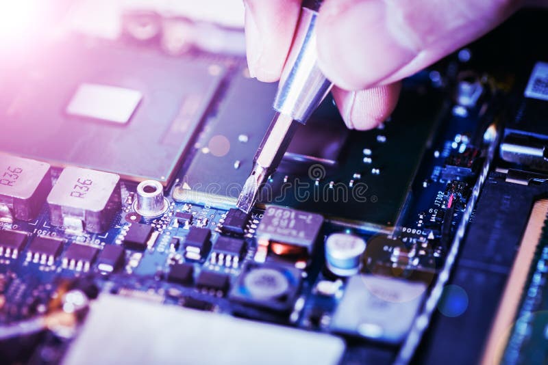 Technician is Fixing a Computer Circuit Board, Hand and Screwdriver ...