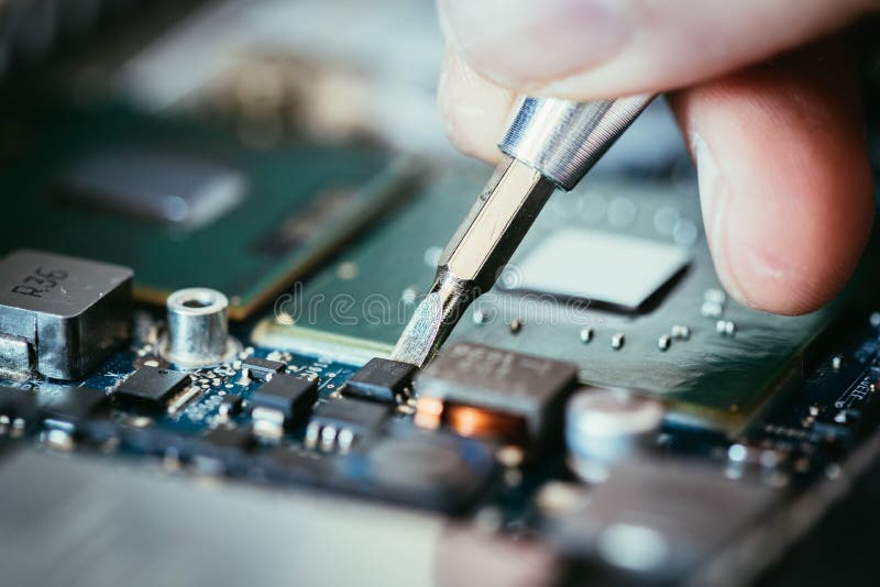 Technician is Fixing a Computer Circuit Board, Hand and Screwdriver ...