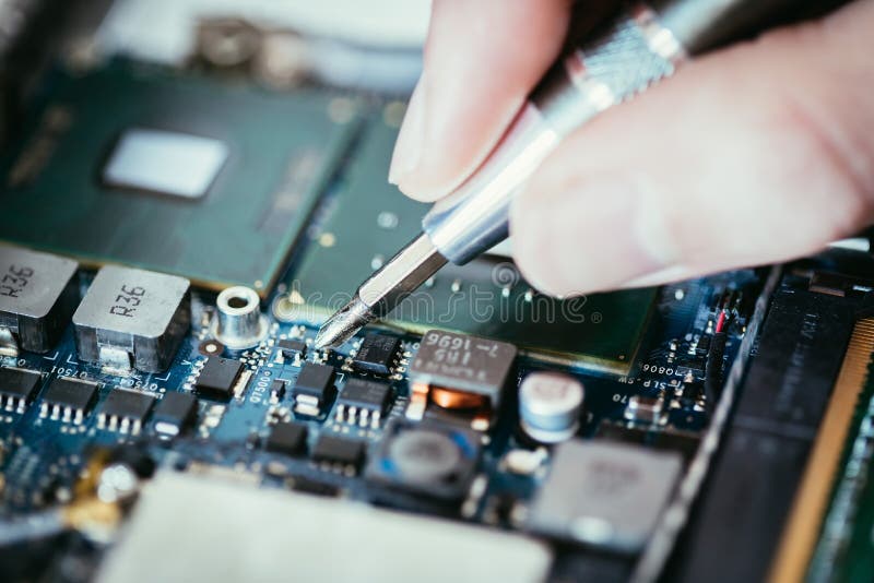 Technician is Fixing a Computer Circuit Board, Hand and Screwdriver ...