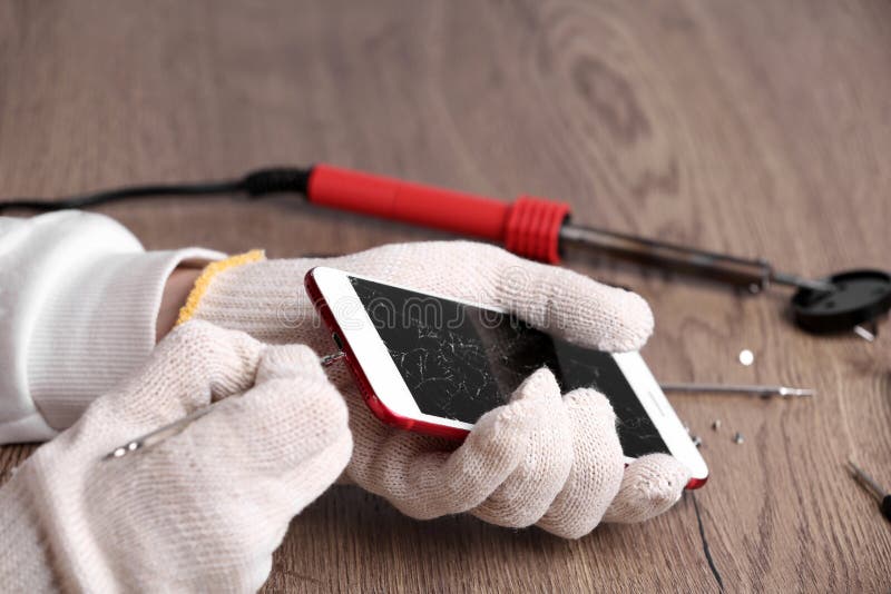 Technician Fixing Mobile Phone at Table. Device Repair Service Stock ...