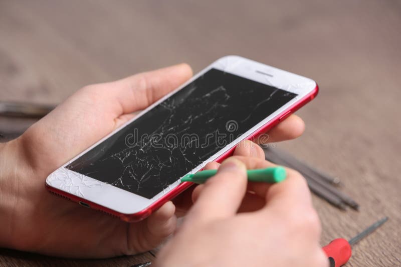 Technician Fixing Mobile Phone at Table. Device Repair Service Stock ... Technician Fixing Mobile Phone at Table. Device Repair Service Stock ...