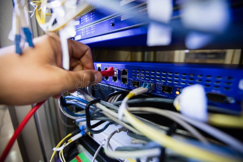 Technician Fixing Patch Cable in a Rack Mounted Server Stock Photo ...