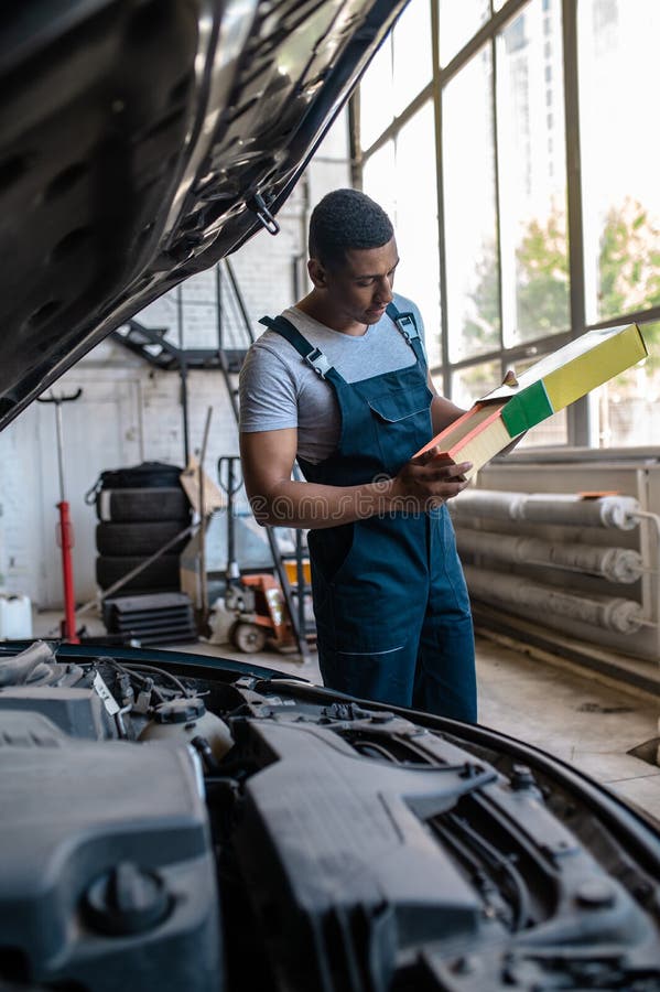 Technician in the Garage Looking Busy and Concentrated Stock Image ...