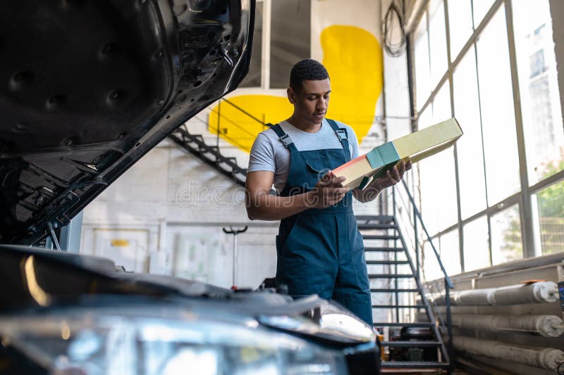 Technician in the Garage Looking Busy and Concentrated Stock Photo ...