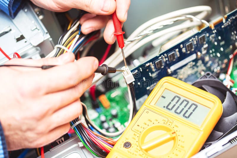 Technician Hands with Voltmeter Above Computer Motherboard. Repair of ...