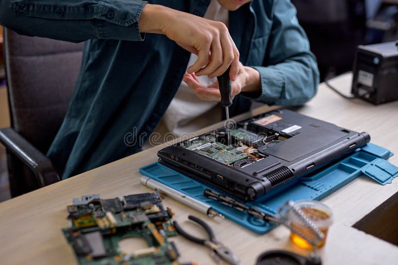 Technician Hold the Screwdriver for Repairing the Laptop. Computer ... Technician Hold the Screwdriver for Repairing the Laptop. Computer ...