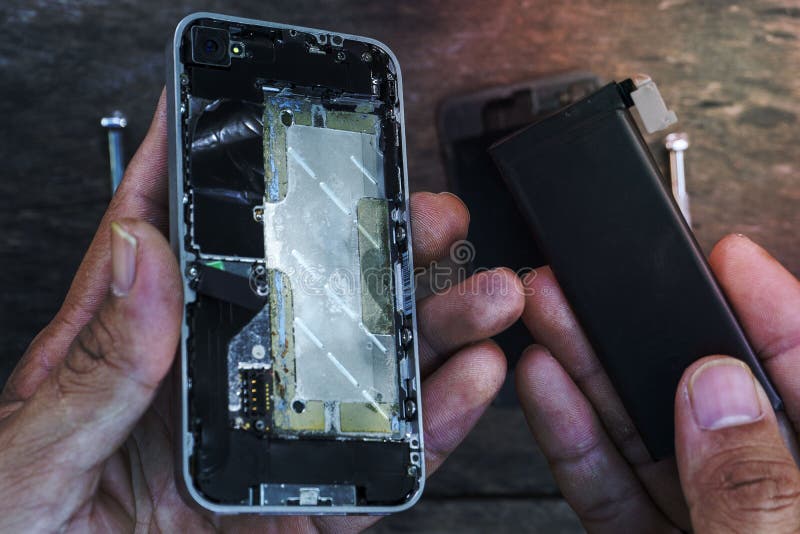 Technician Holding an Open Mobile Phone and Showing the Inside of it ...