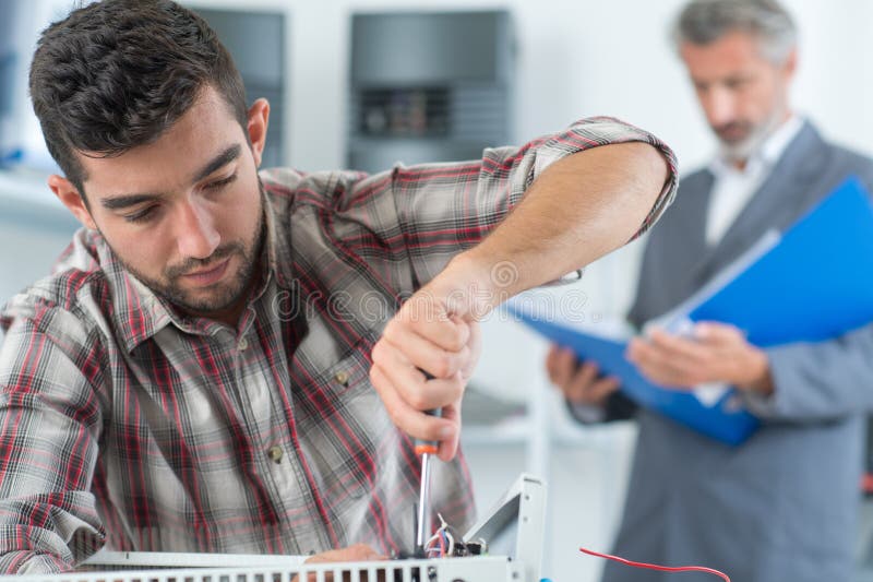 Technician Installing Digital Thermostat Using Screwdriver Stock Image ...