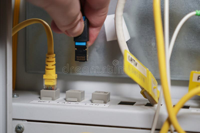 Technician Installing Ethernet Cable into Network Panel for Internet ...