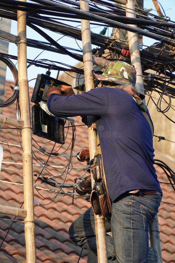 The Technician is Installing Fiber Optic for Internet Network Stock ...