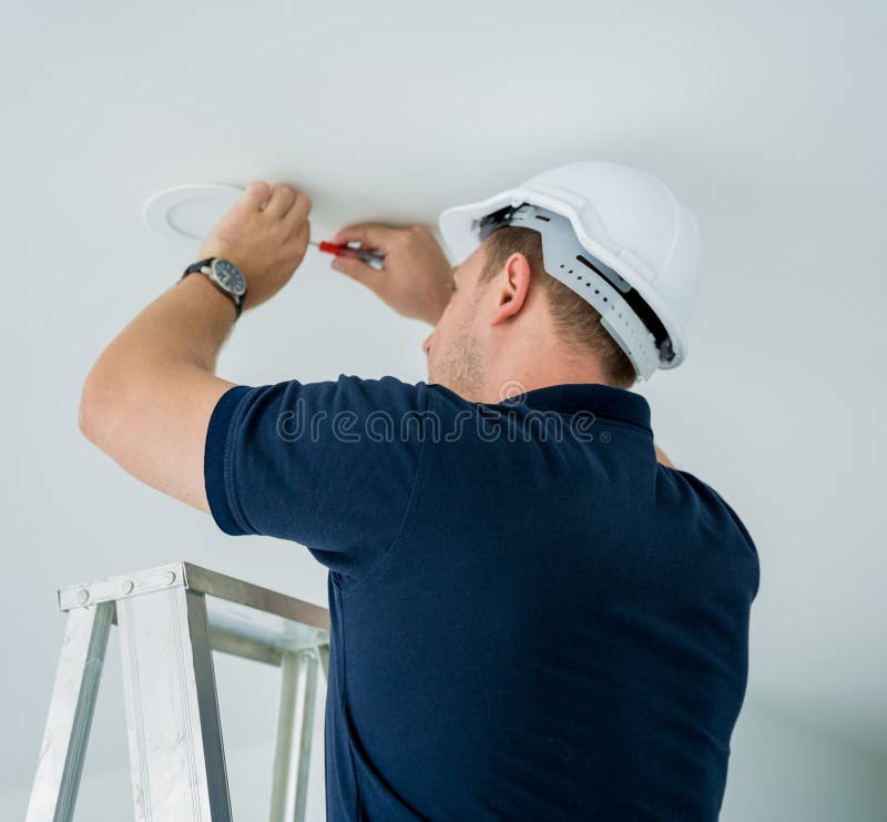Technician is Installing an LED Spotlight in the Ceiling. Stock Image ...