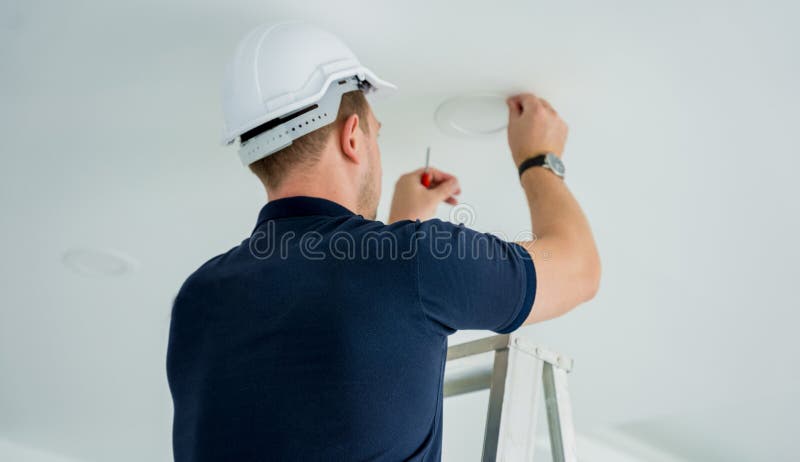 Technician is Installing an LED Spotlight in the Ceiling. Stock Image ...