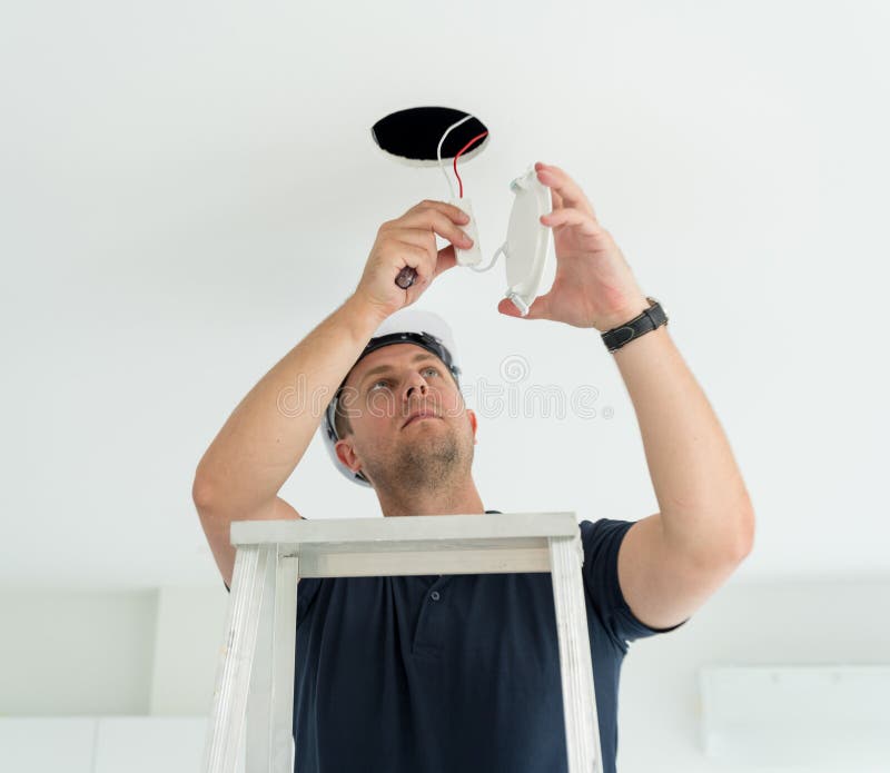 Technician is Installing an LED Spotlight in the Ceiling. Stock Image ...