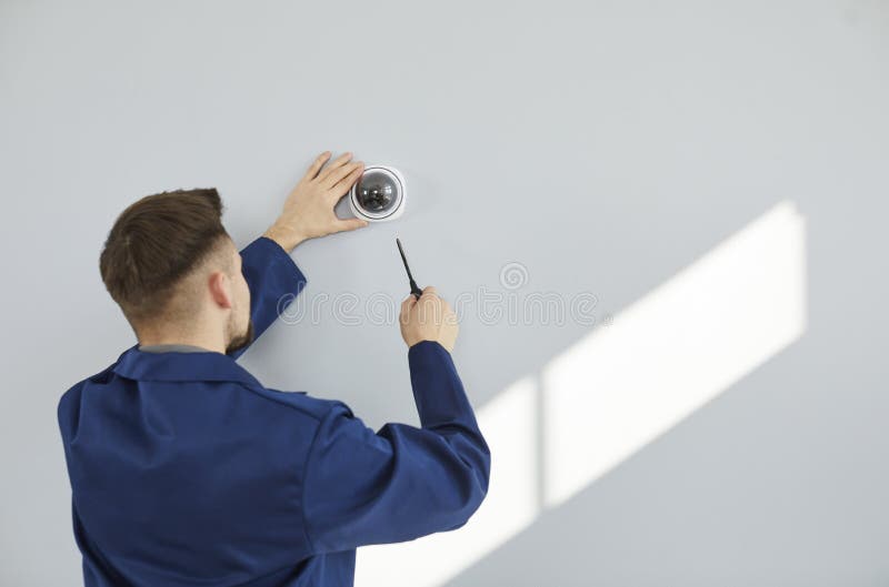 Technician Installing Modern Surveillance CCTV Dome Camera on Wall ...