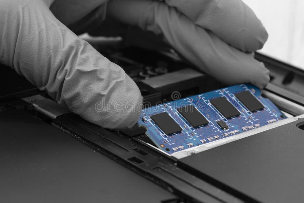 Technician Installing RAM into the Memory Slot on a Laptop Computer ...