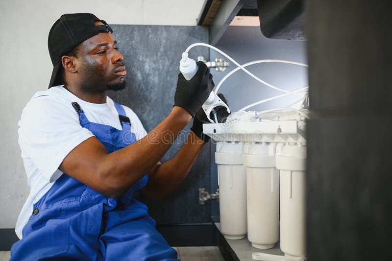 Technician Installing Reverse Osmosis Equipment Under the Sink Stock ...