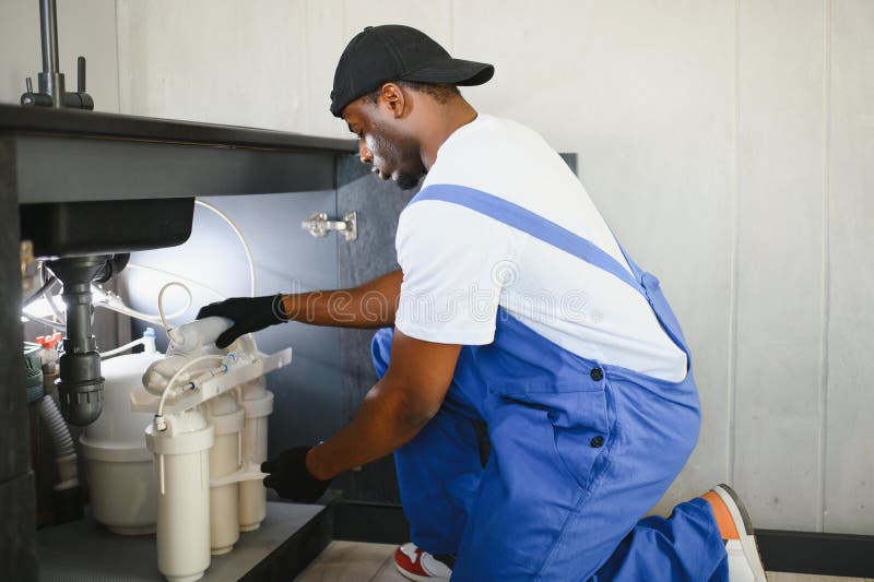 Afro Repairman in Blue Using Tools while Installing or Repairing ...