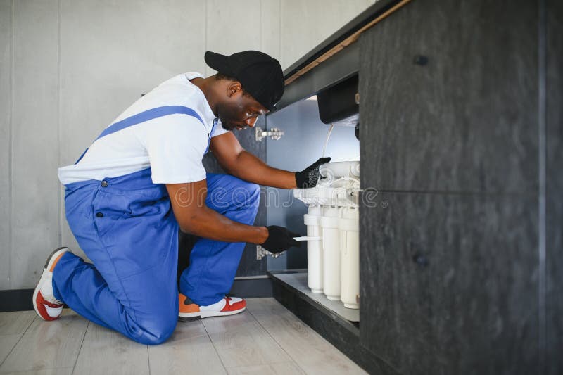 Afro Repairman in Blue Using Tools while Installing or Repairing ...