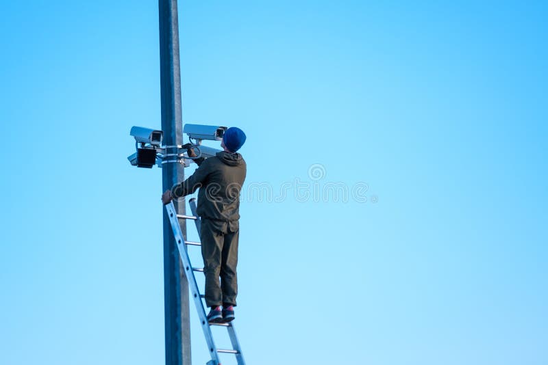 Technician Installing Security Cameras on Pole Stock Image - Image of ...