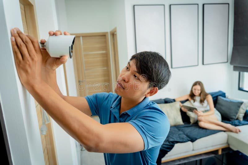 A Technician Installs a CCTV Camera in a Modern Apartment. Stock Image ...