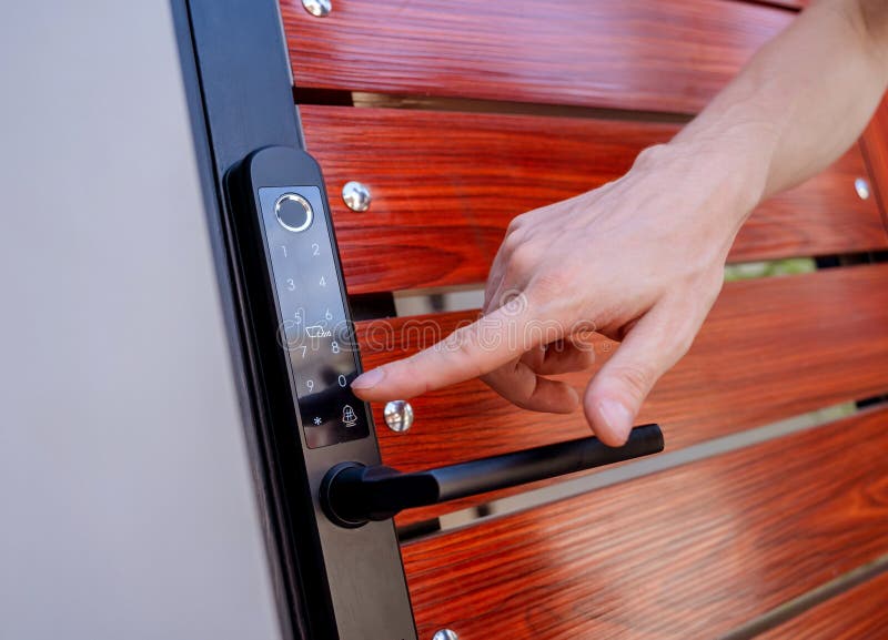 A Technician Installs a Modern Smart Door Lock on the Wood Door Stock ...