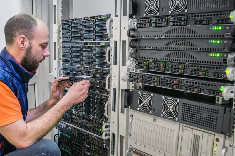 The Technician Installs a New Battery Pack into the Uninterruptible ...