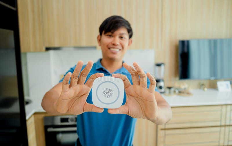 A Technician Installs a Security Alarm Siren in a Modern Apartment ...