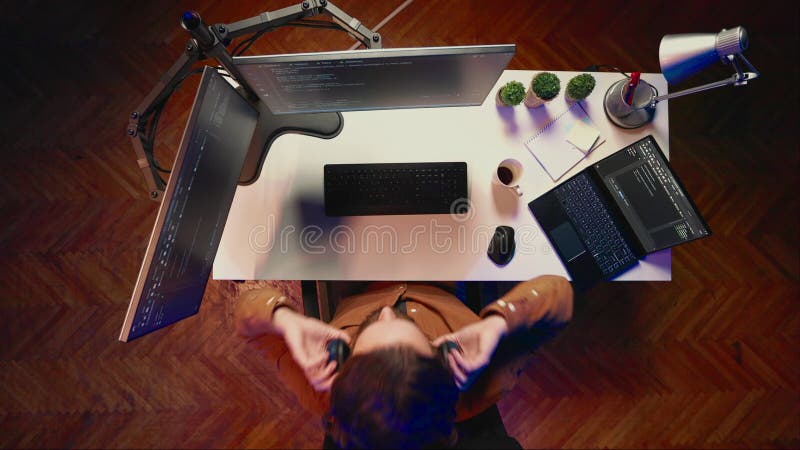 Technician Listening Music while Using Coding To Fortify Firewalls ...