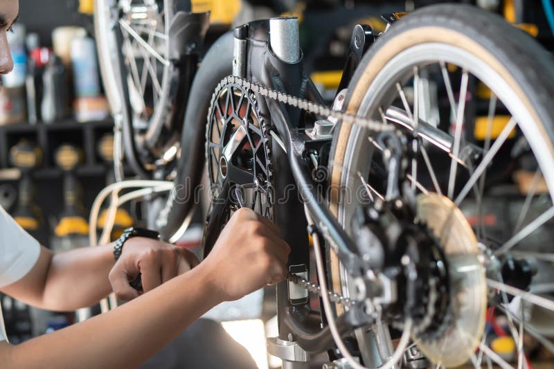 Technician Makes Adjustments To Crankset on a Folding Bicycle Working ...