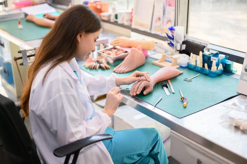 Technician Making Prosthetic Device Using Grinder To Smooth Socket ...