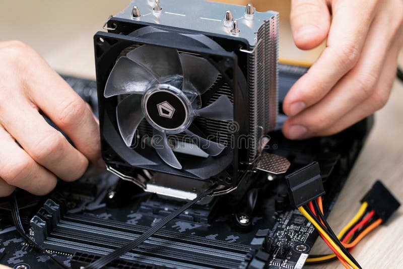 Technician Man Installs Air-cooled Heatsink on Desktop CPU Covered with ...