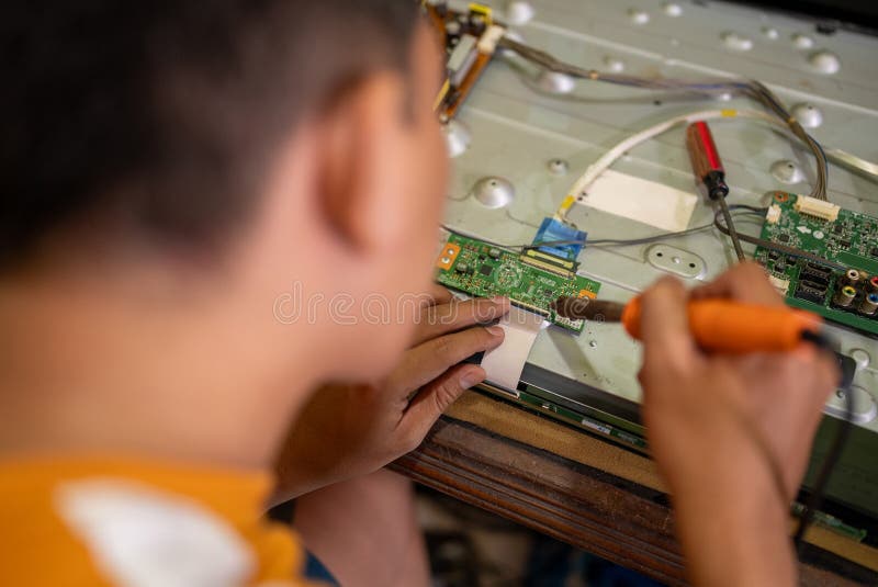 Technician Man Uses Soldering Iron To Replace Electronic Component ...