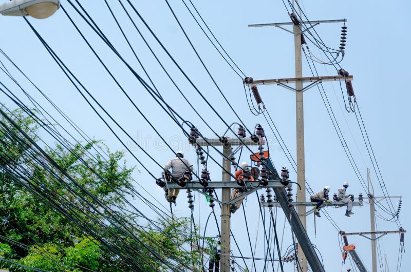 Technician Men Fixing or Repairing Broken Power Line on Electric Pole ...