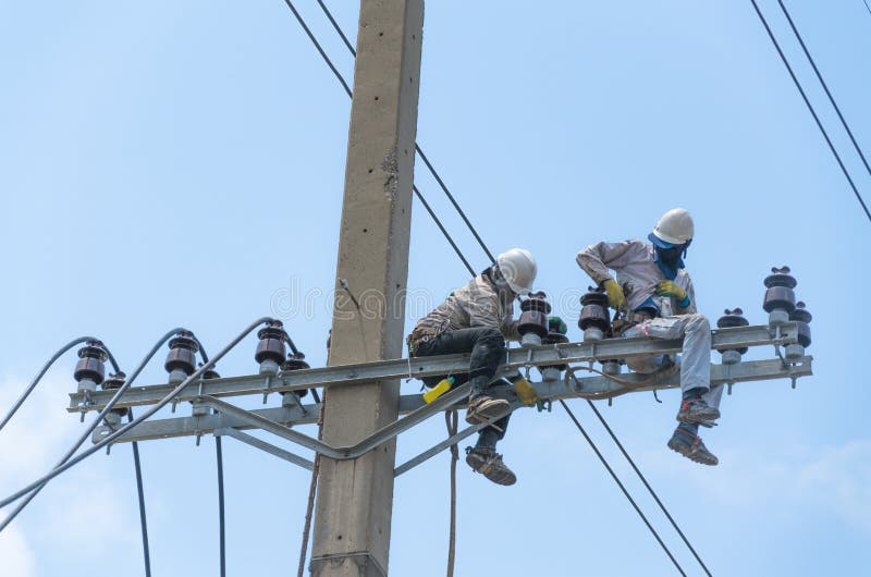 Technician Men Fixing or Repairing Broken Power Line on Electric Pole ...