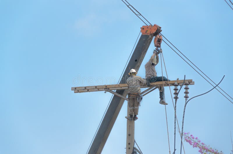 Technician Men Fixing or Repairing Broken Power Line on Electric Pole ...